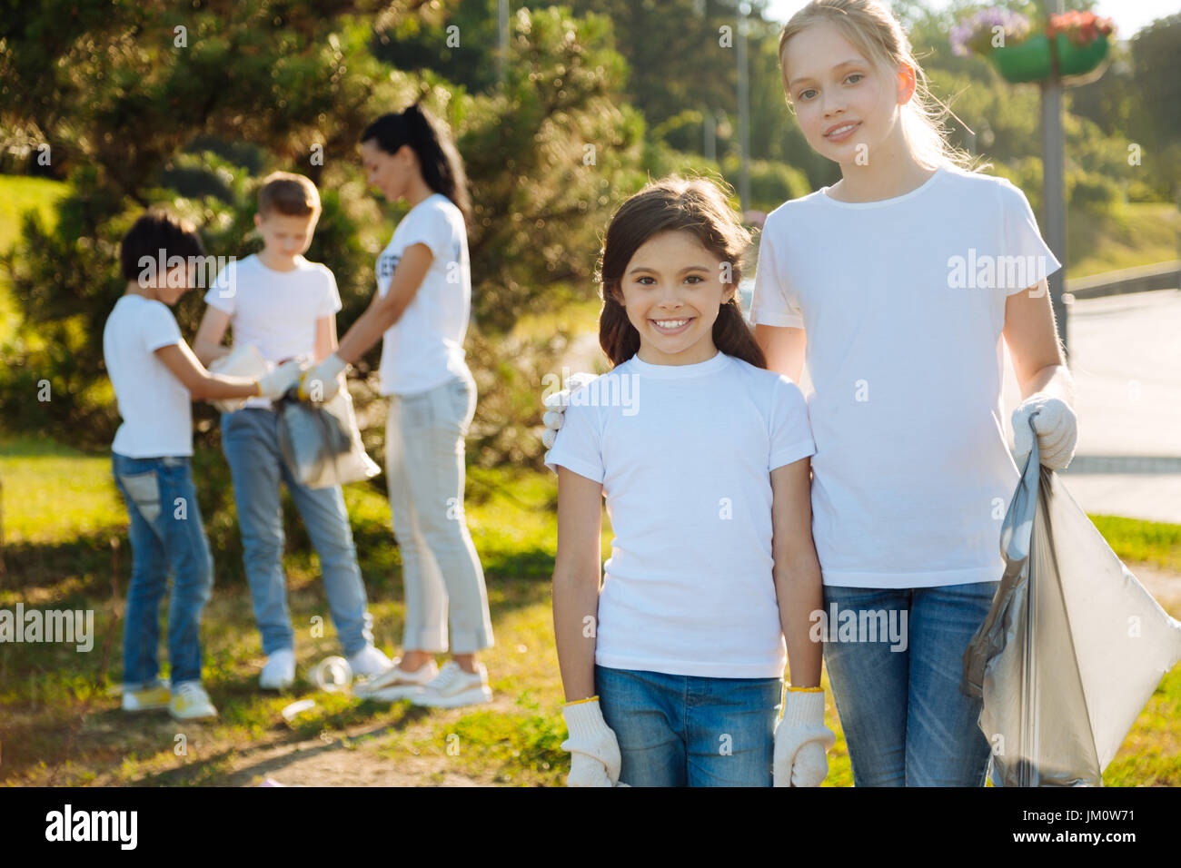 Merciful friends smiling after cleaning Stock Photo - Alamy