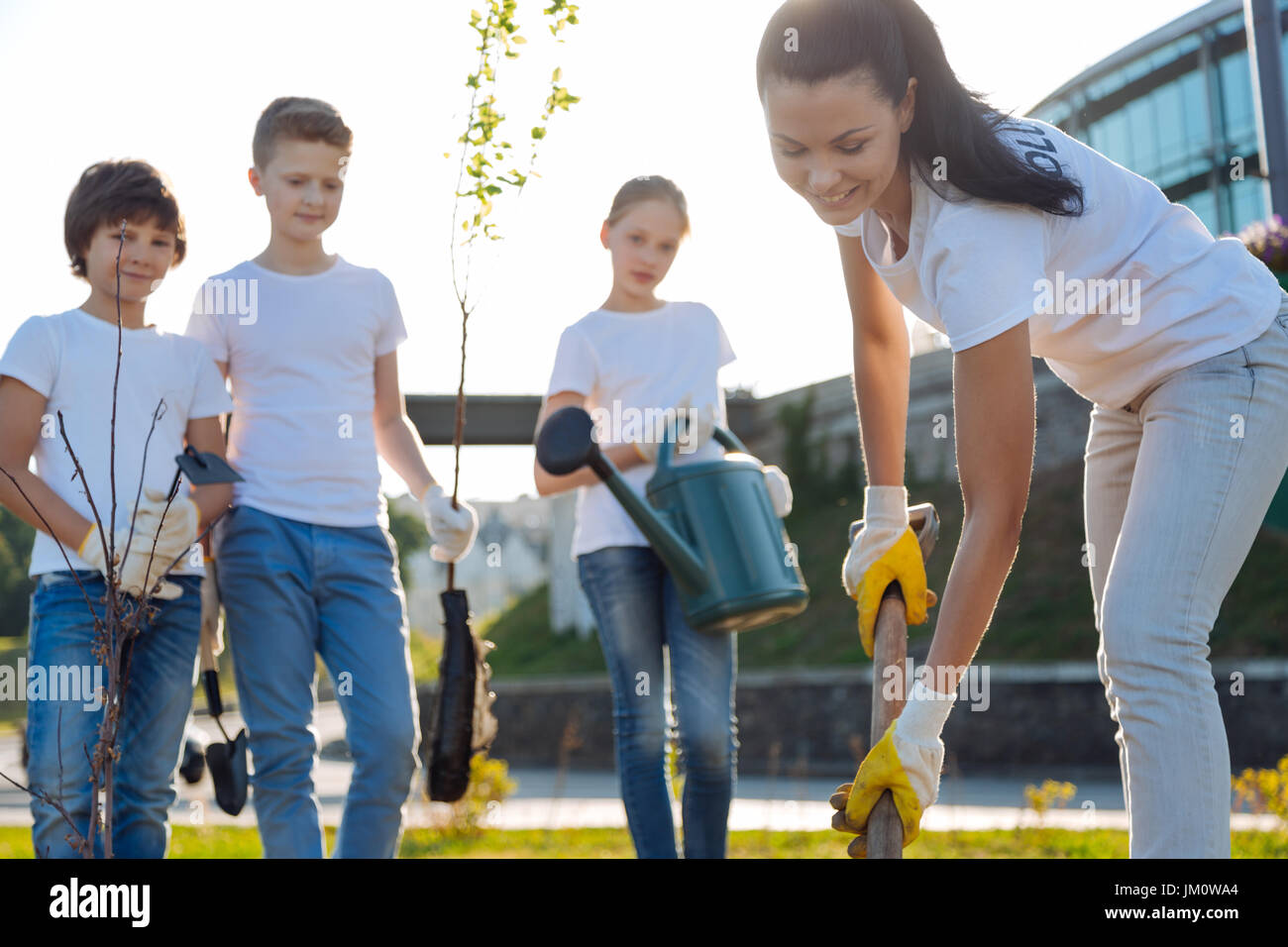 Kind teacher helping her students Stock Photo - Alamy