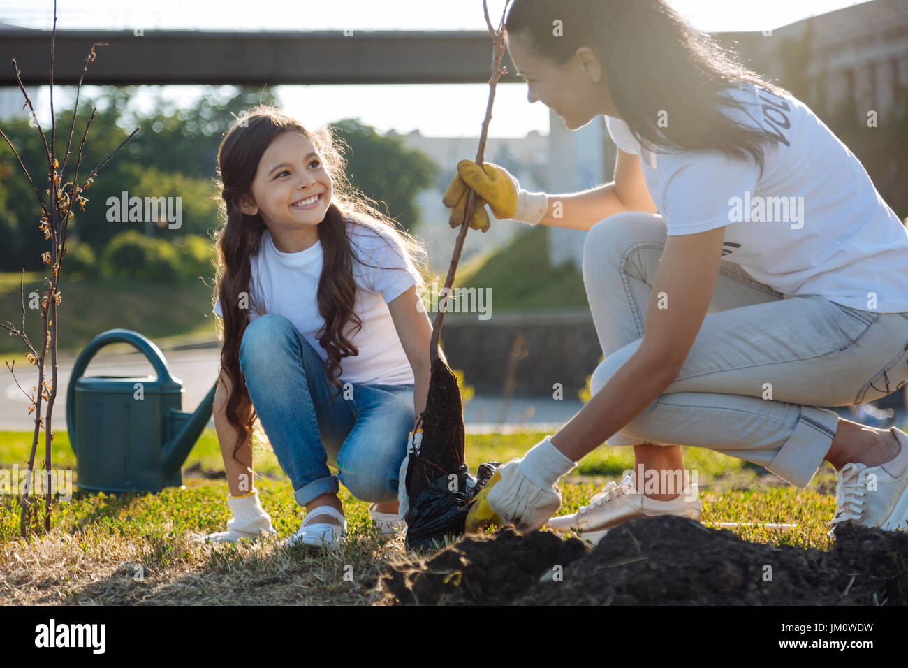 Remember it as moment. Attractive volunteer keeping smile on her face ...