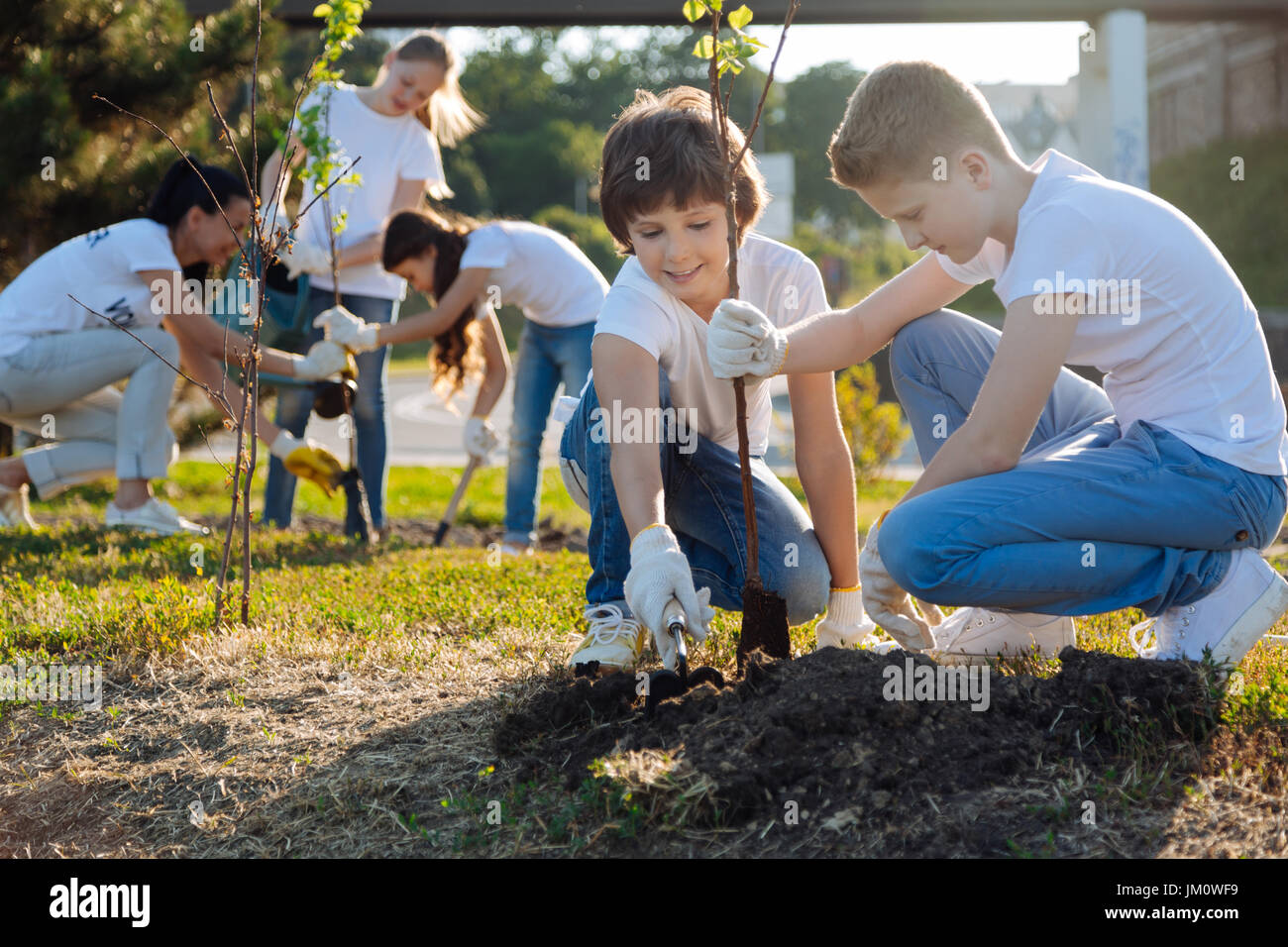 Children planting trees hi-res stock photography and images - Alamy