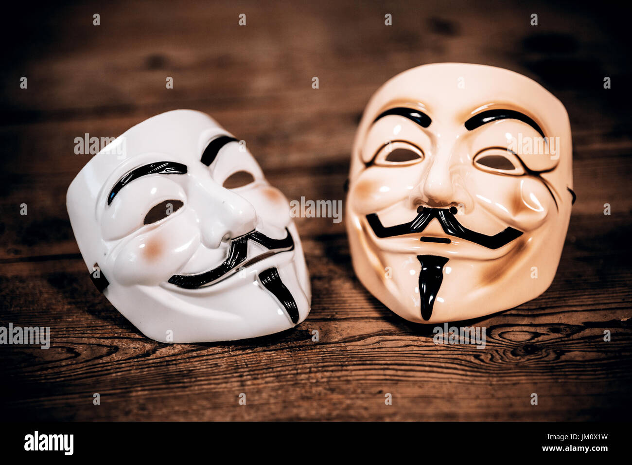 white and yellow anonymous masks on wood background - retro style Stock ...