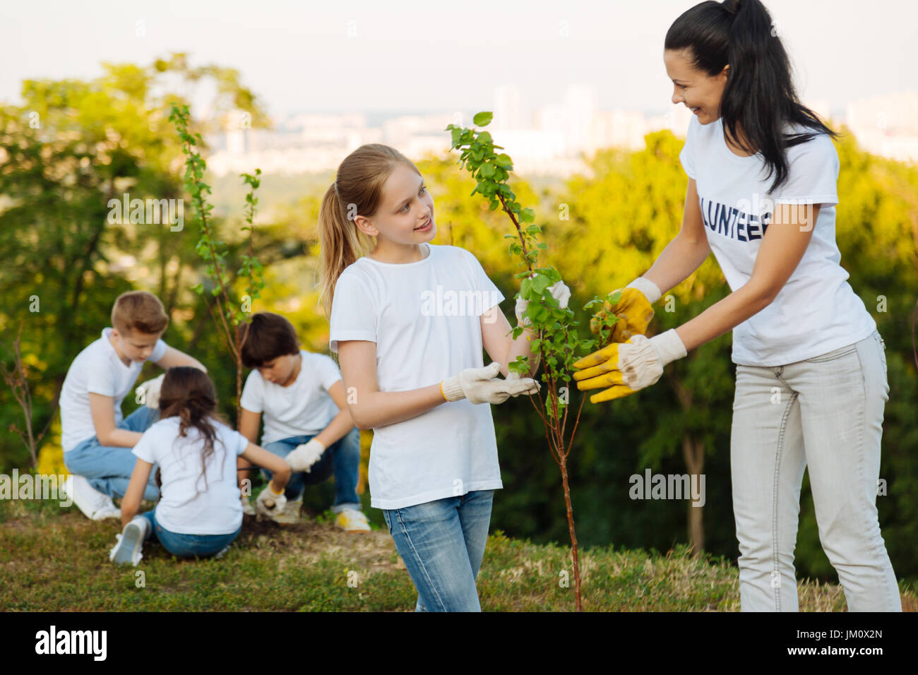 Friendly girl helping her favorite teacher Stock Photo - Alamy