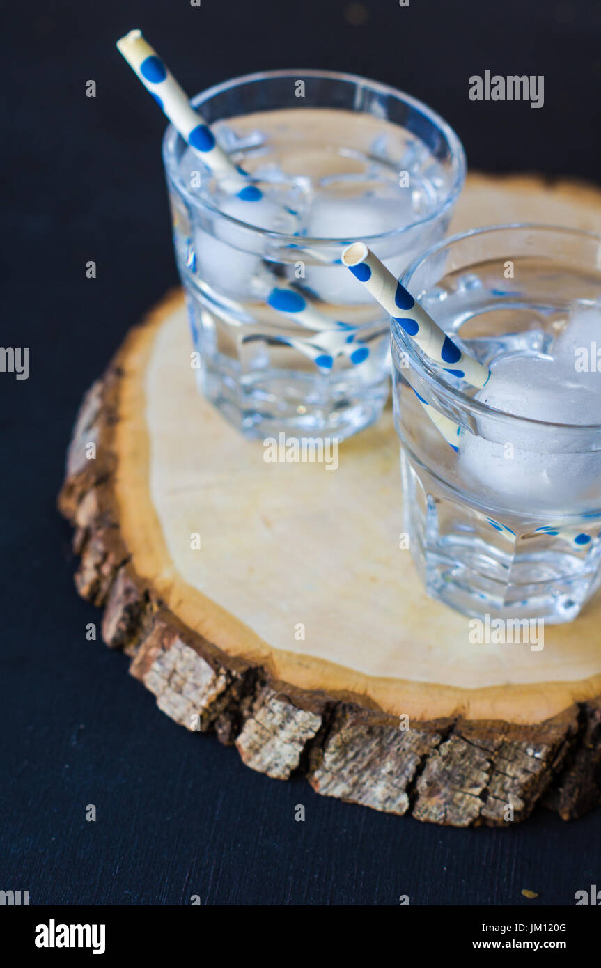 Summer drink glass of water with ice on dark background Stock Photo - Alamy