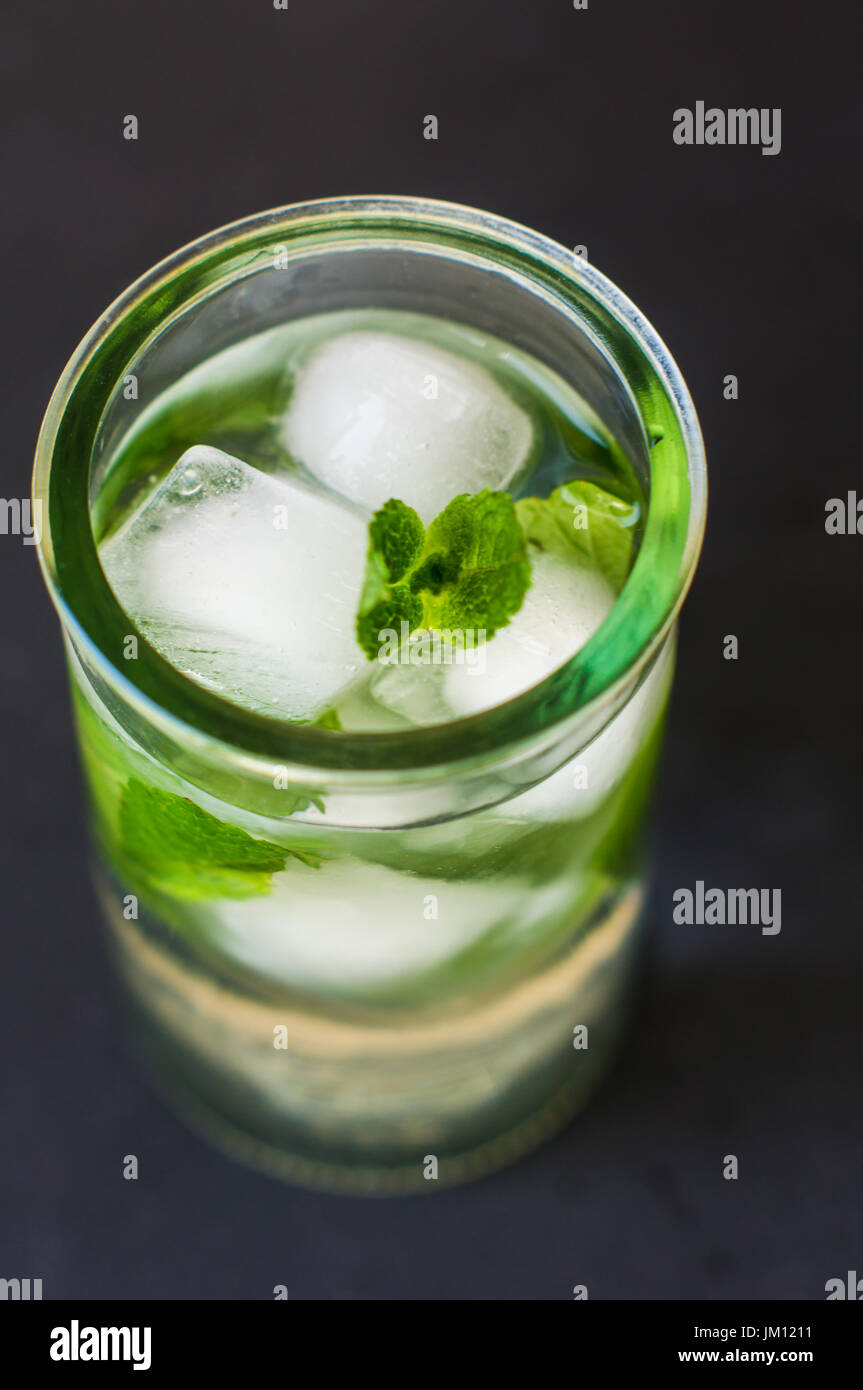 Summer drink glass of water with ice on dark background Stock Photo - Alamy