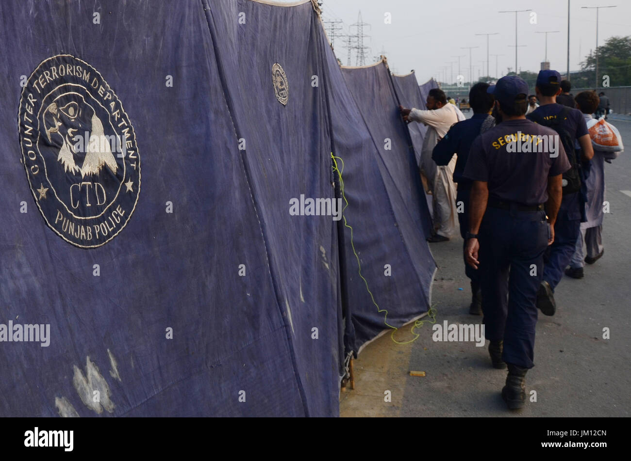 Pakistani security officials cordon off the scene of a suicide bomb ...