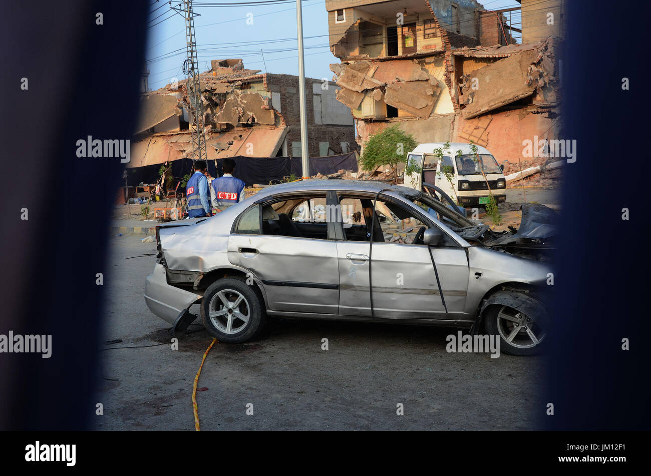 Pakistani security officials cordon off the scene of a suicide bomb ...