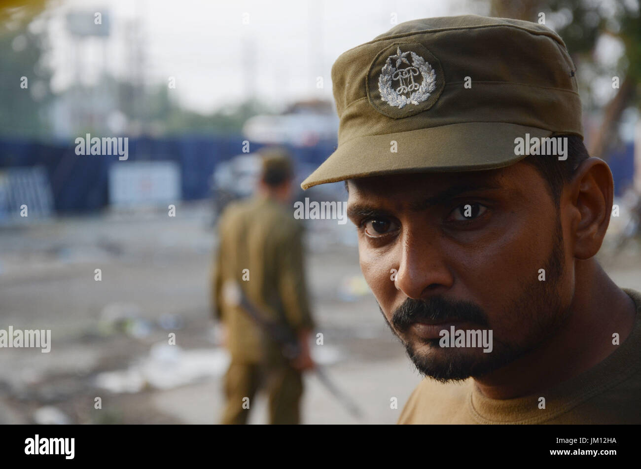 Pakistani security officials cordon off the scene of a suicide bomb ...