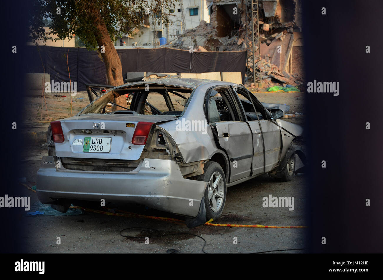 Pakistani security officials cordon off the scene of a suicide bomb ...