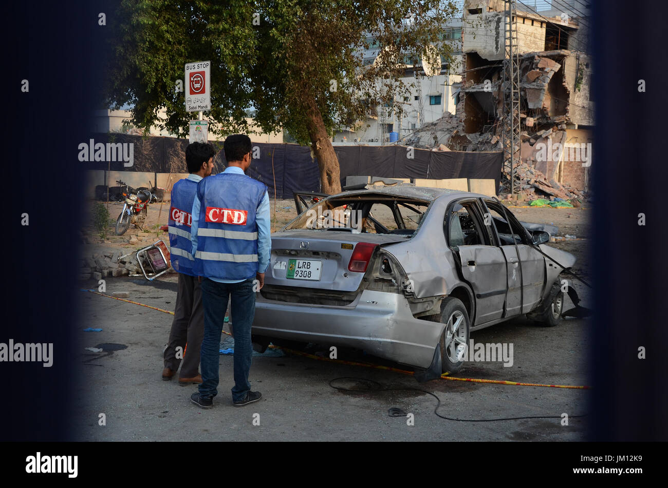 Pakistani security officials cordon off the scene of a suicide bomb ...