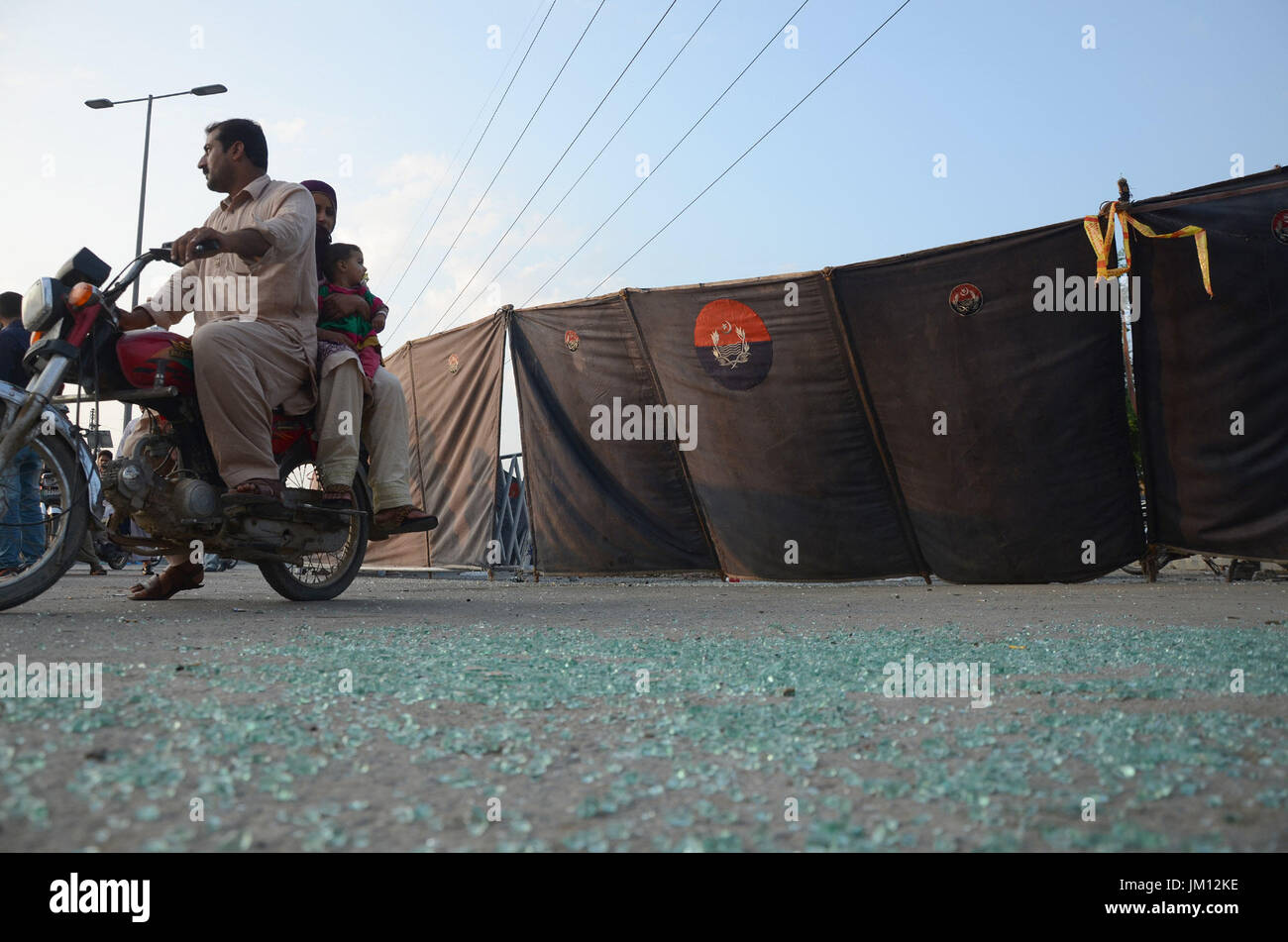 Pakistani security officials cordon off the scene of a suicide bomb ...
