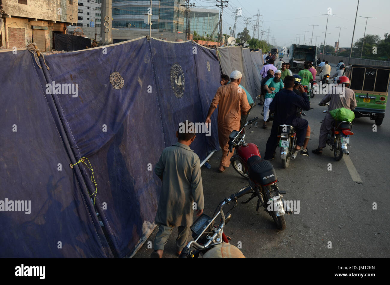 Pakistani security officials cordon off the scene of a suicide bomb ...