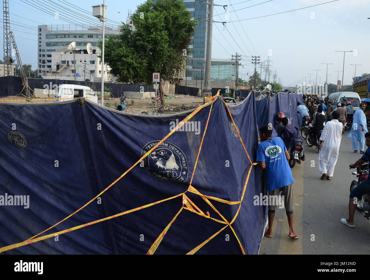 Pakistani security officials cordon off the scene of a suicide bomb ...