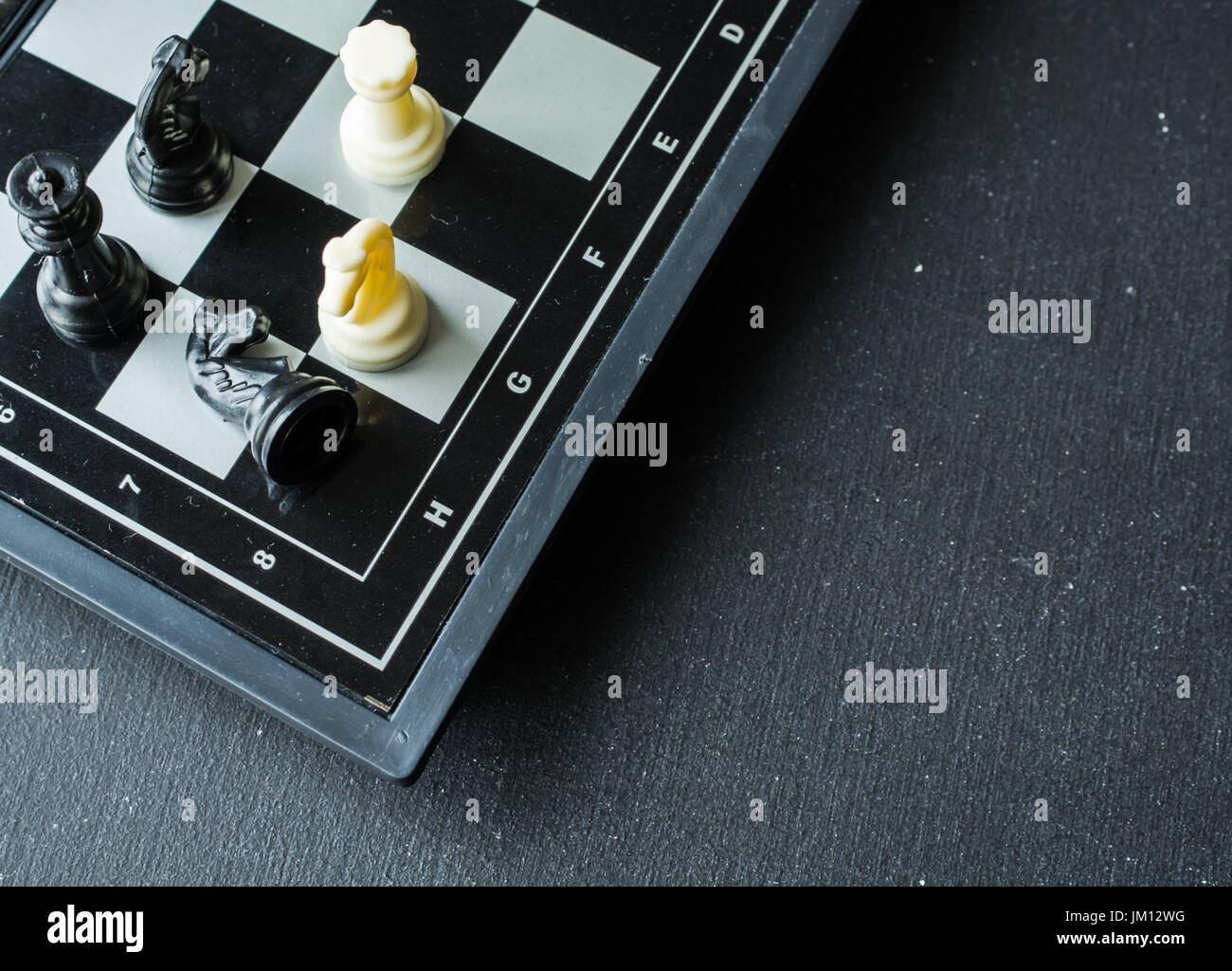Chess board game on dark wooden table Stock Photo - Alamy