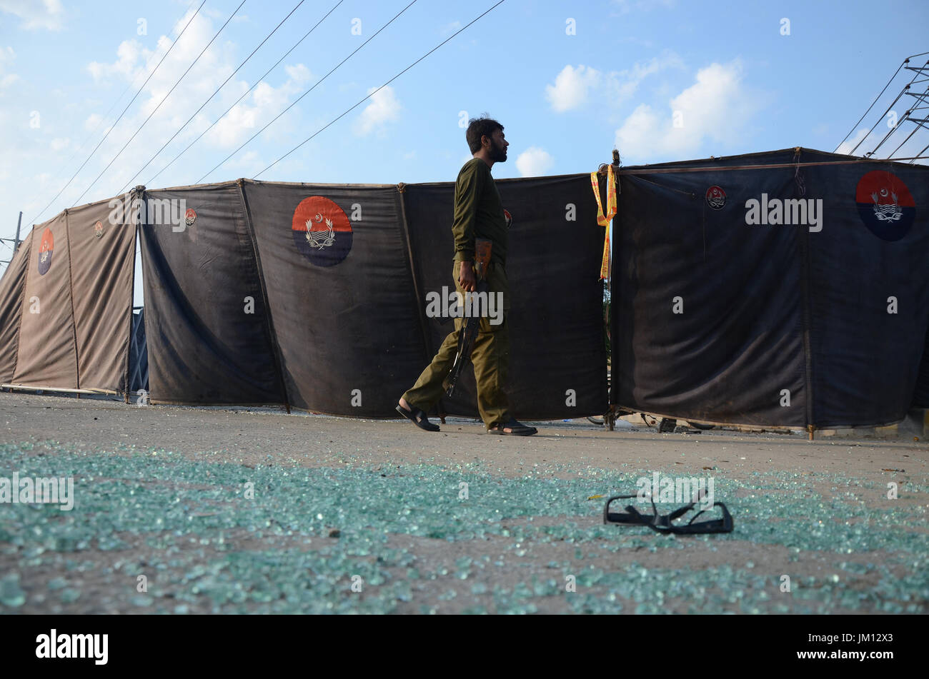Pakistani security officials cordon off the scene of a suicide bomb ...