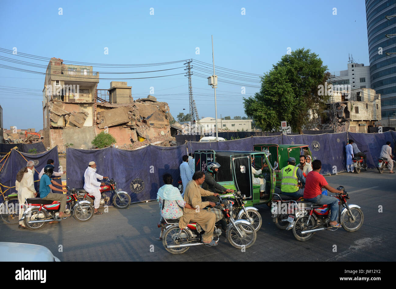 Pakistani security officials cordon off the scene of a suicide bomb ...