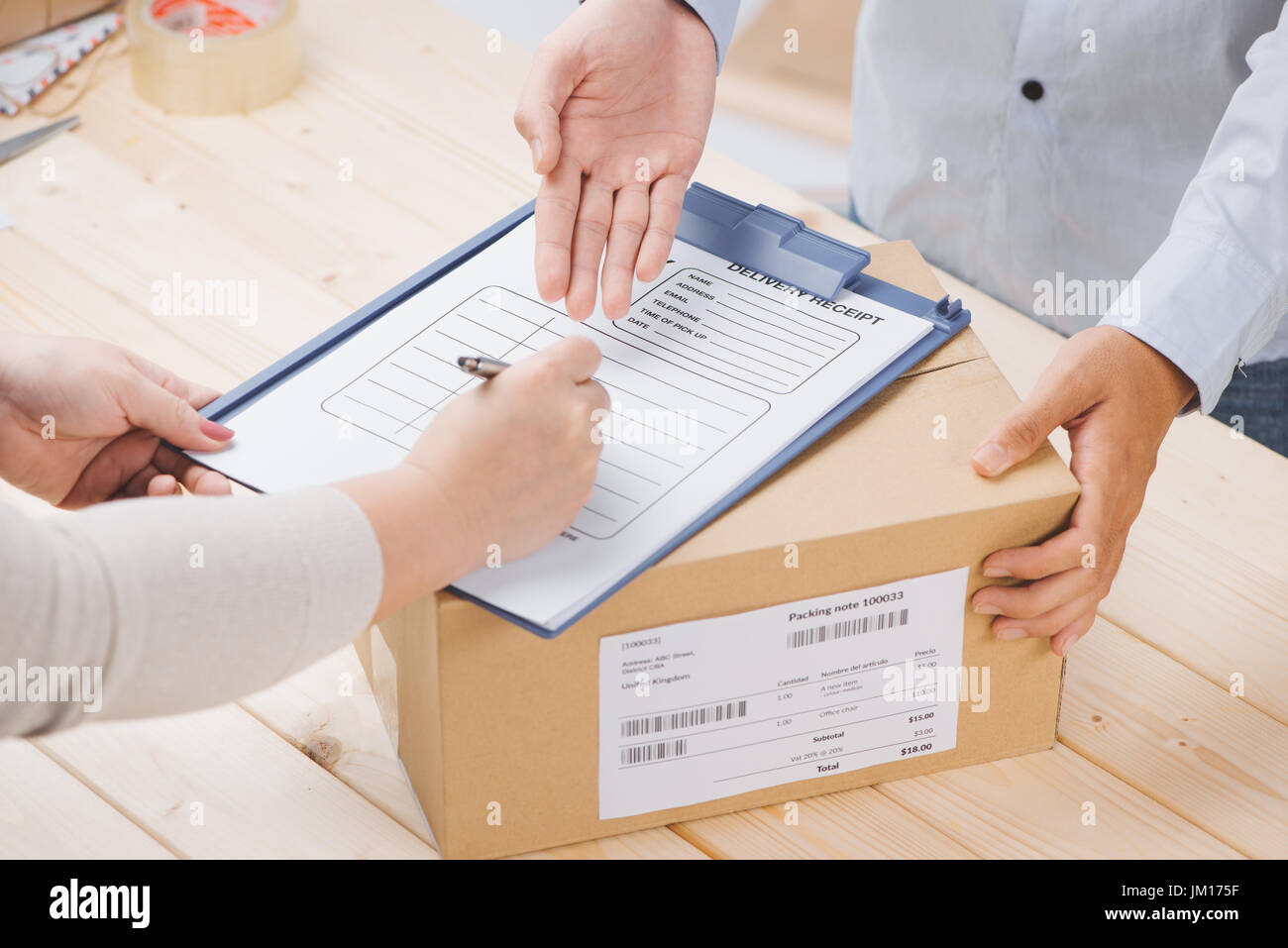 Woman signing receipt of delivery package, close up Stock Photo - Alamy