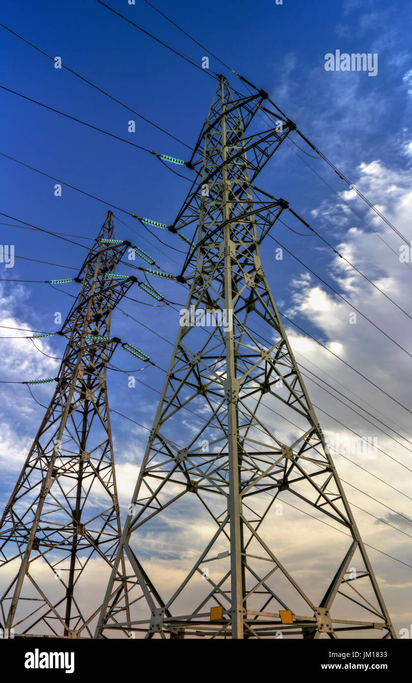 High voltage electrical overhead lines on blue sky Stock Photo - Alamy
