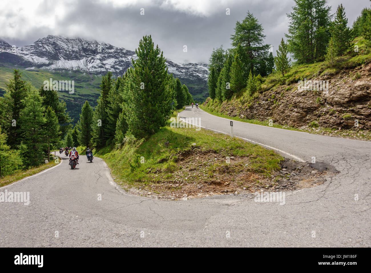 U-shape curved road in gavia pass with cyclists and motorbikes Stock ...