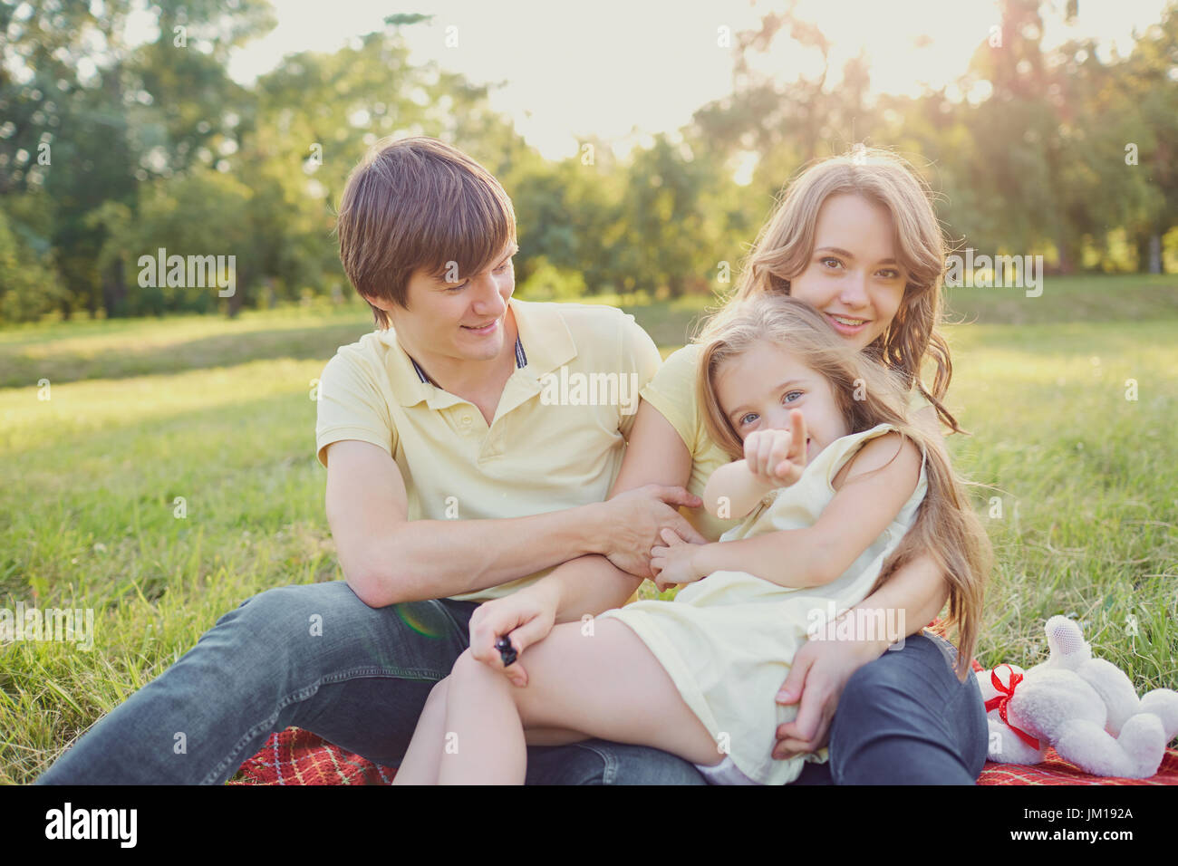Happy family in summer park Stock Photo - Alamy