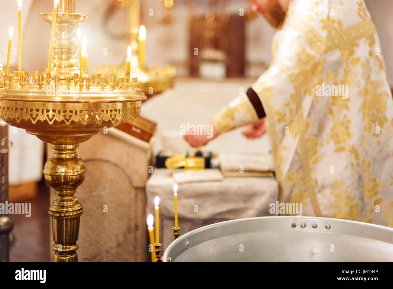Priest wearing gold robe on ceremony in christian cathedral church ...