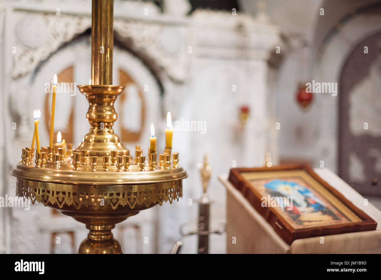 Orthodox christian church interior. Icon and candles during worship ...
