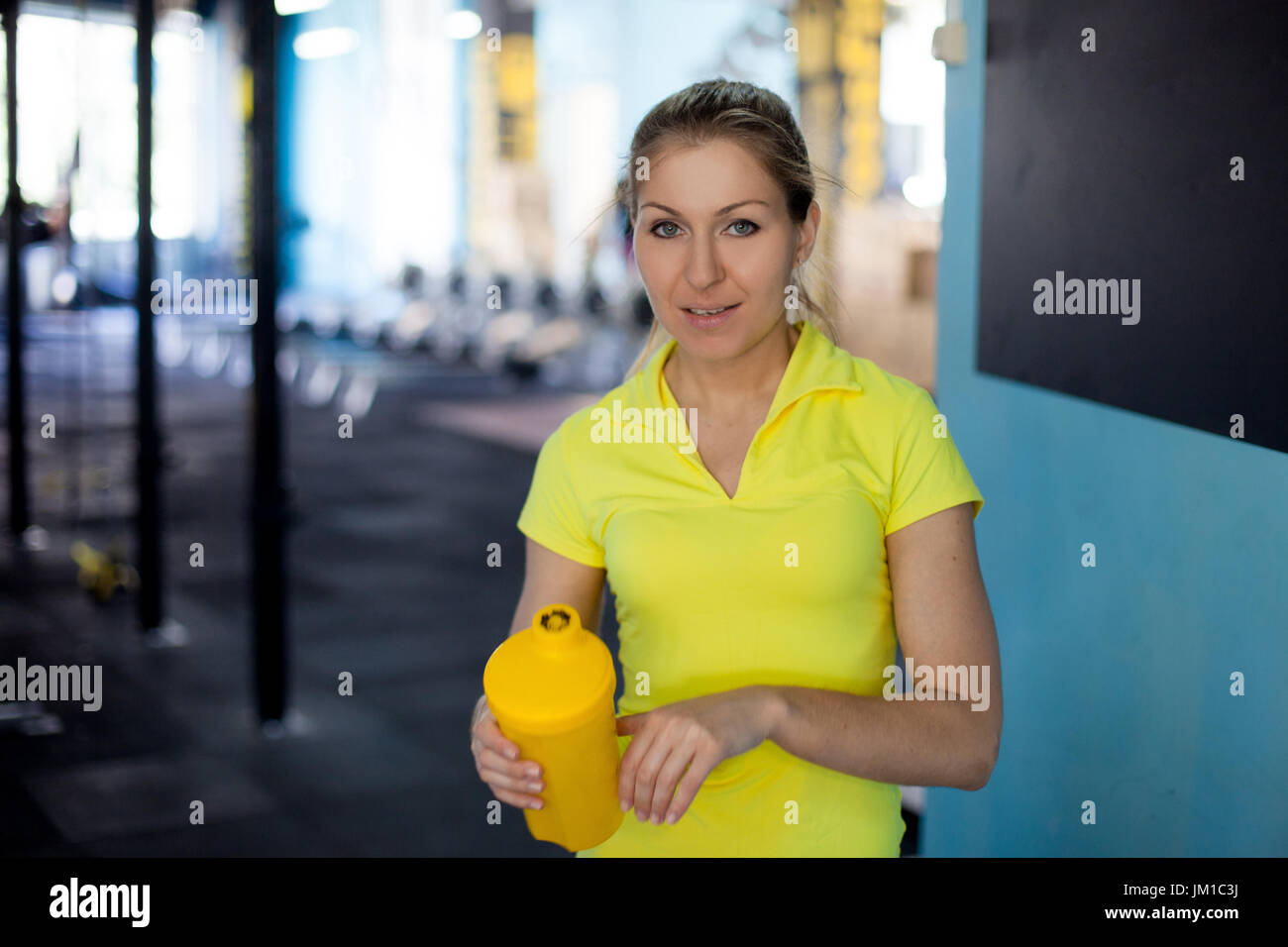 Girl athlete ready to workout. Shaker sports nutrition in the hands ...