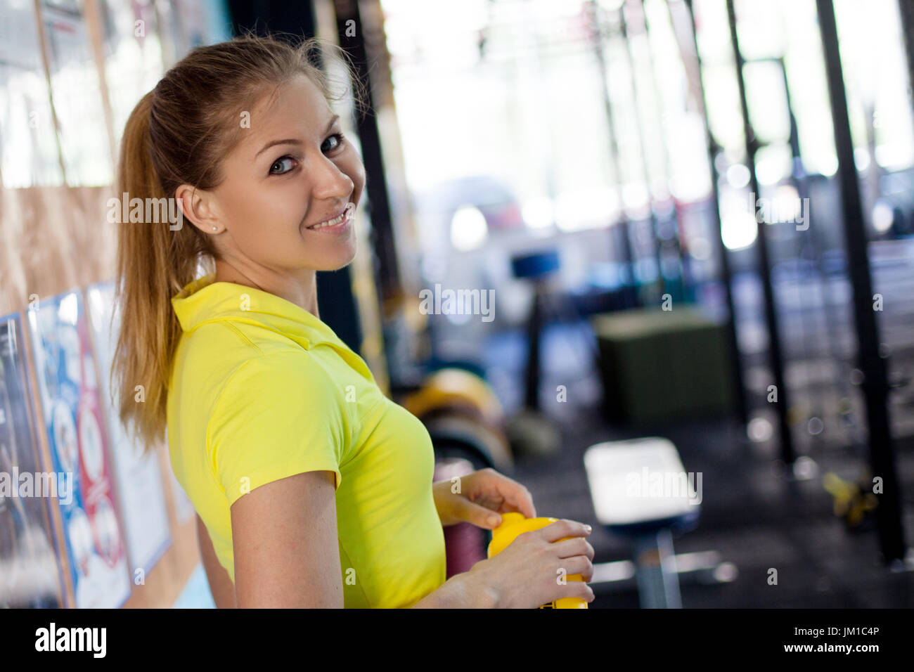 Girl athlete ready to workout. Shaker sports nutrition in the hands ...
