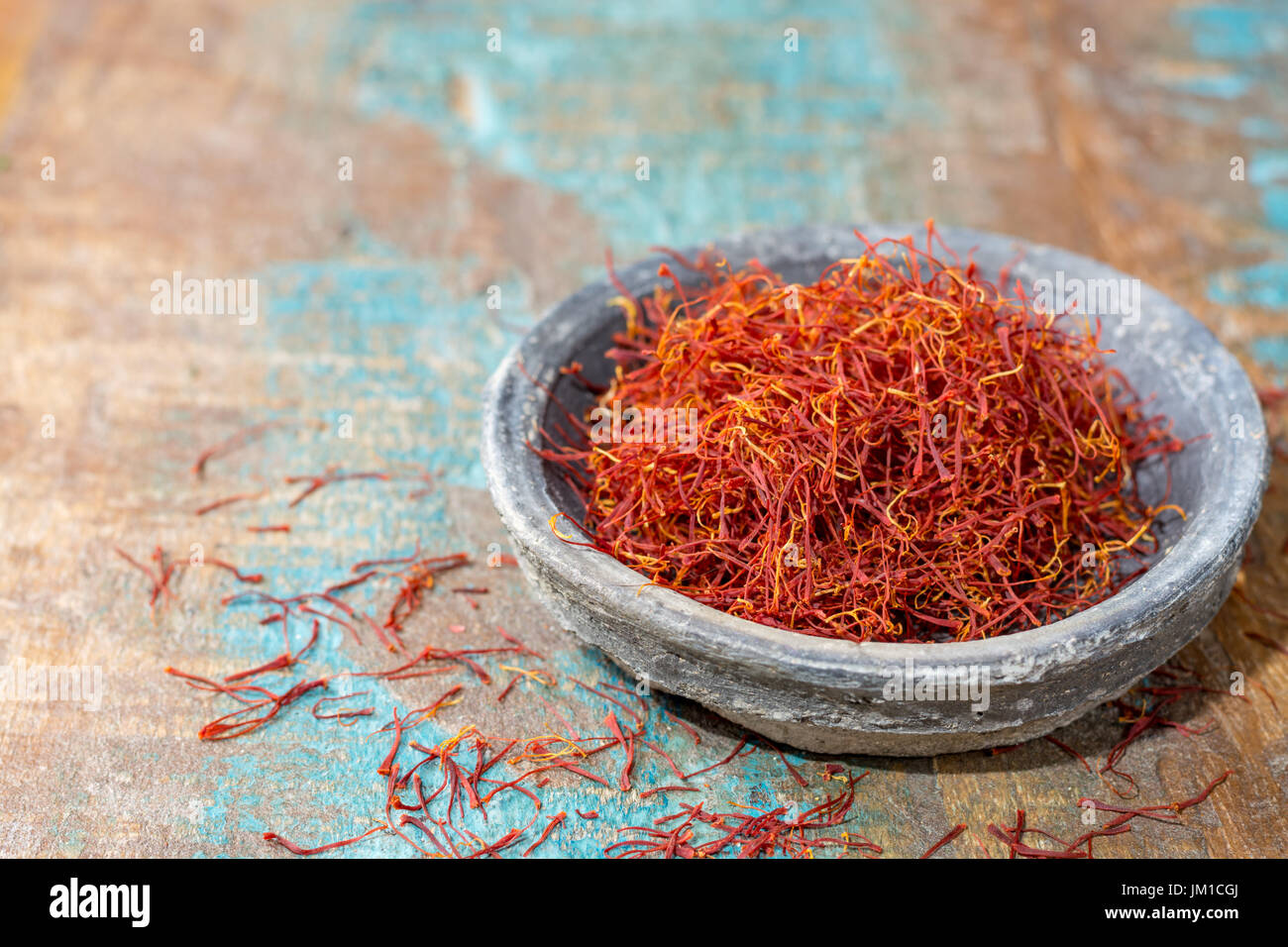 Dried organic red saffron Spice on wooden background with spoon Stock ...