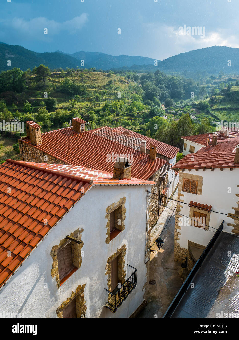 Small spanish village in the moutains. White houses in front, vineyards ...