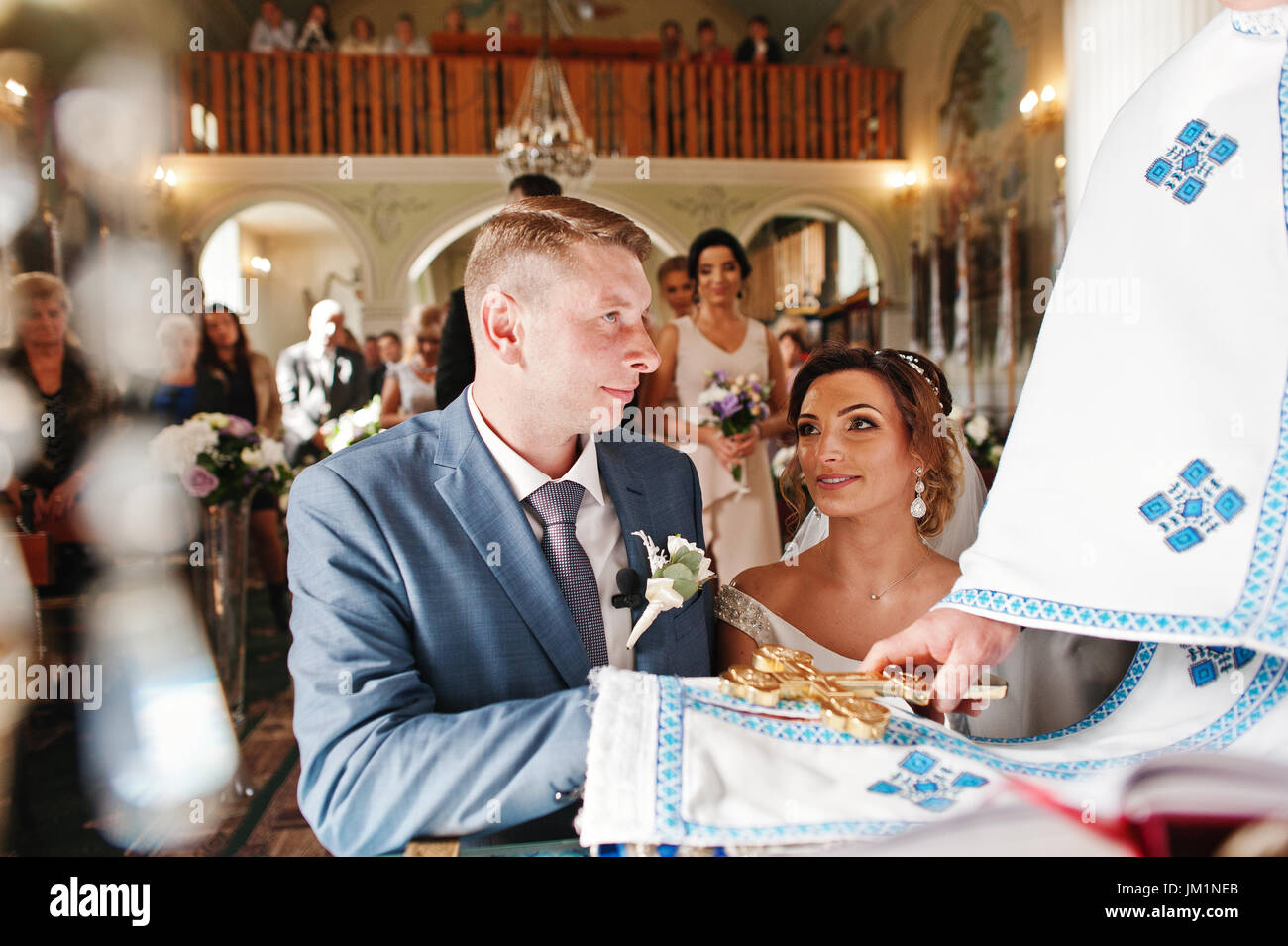 Beautiful wedding couple making vows during wedding ceremony in the ...