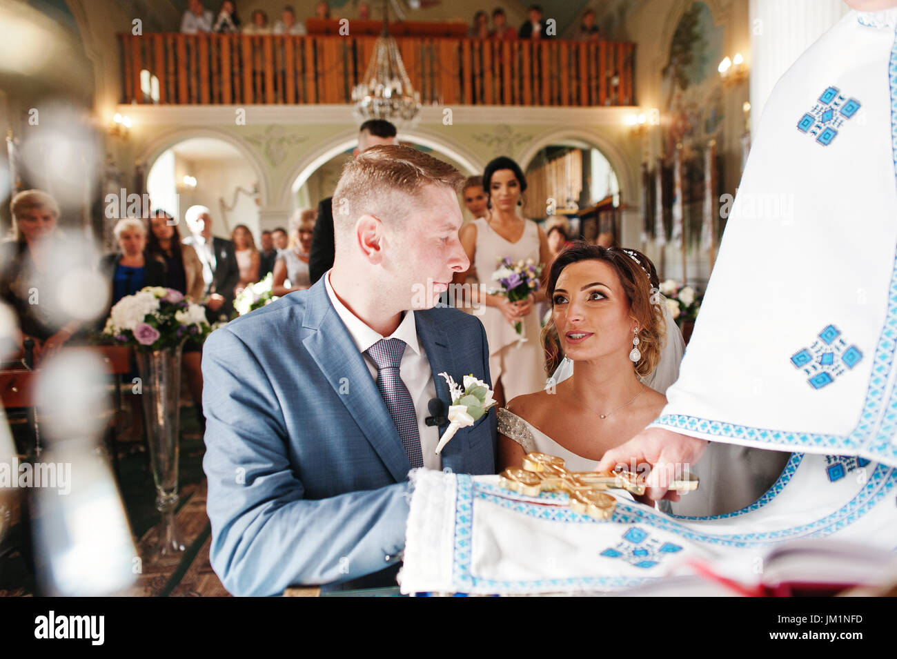 Beautiful wedding couple making vows during wedding ceremony in the ...
