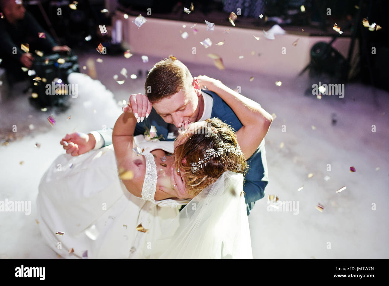 Newly married couple dancing on their wedding party with heavy smoke ...