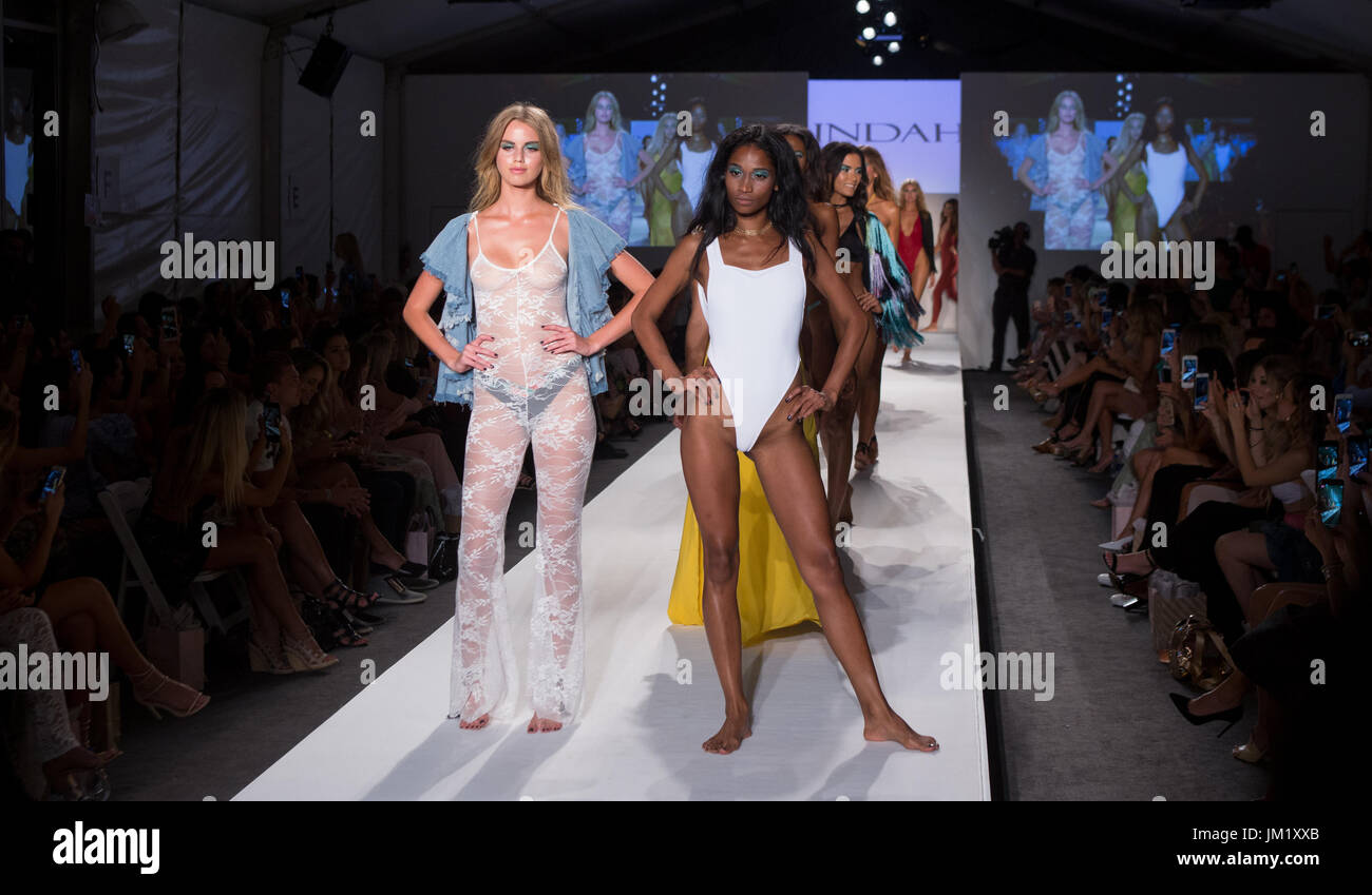 MIAMI BEACH, FL - JULY 23: A model walks the runway during the ...