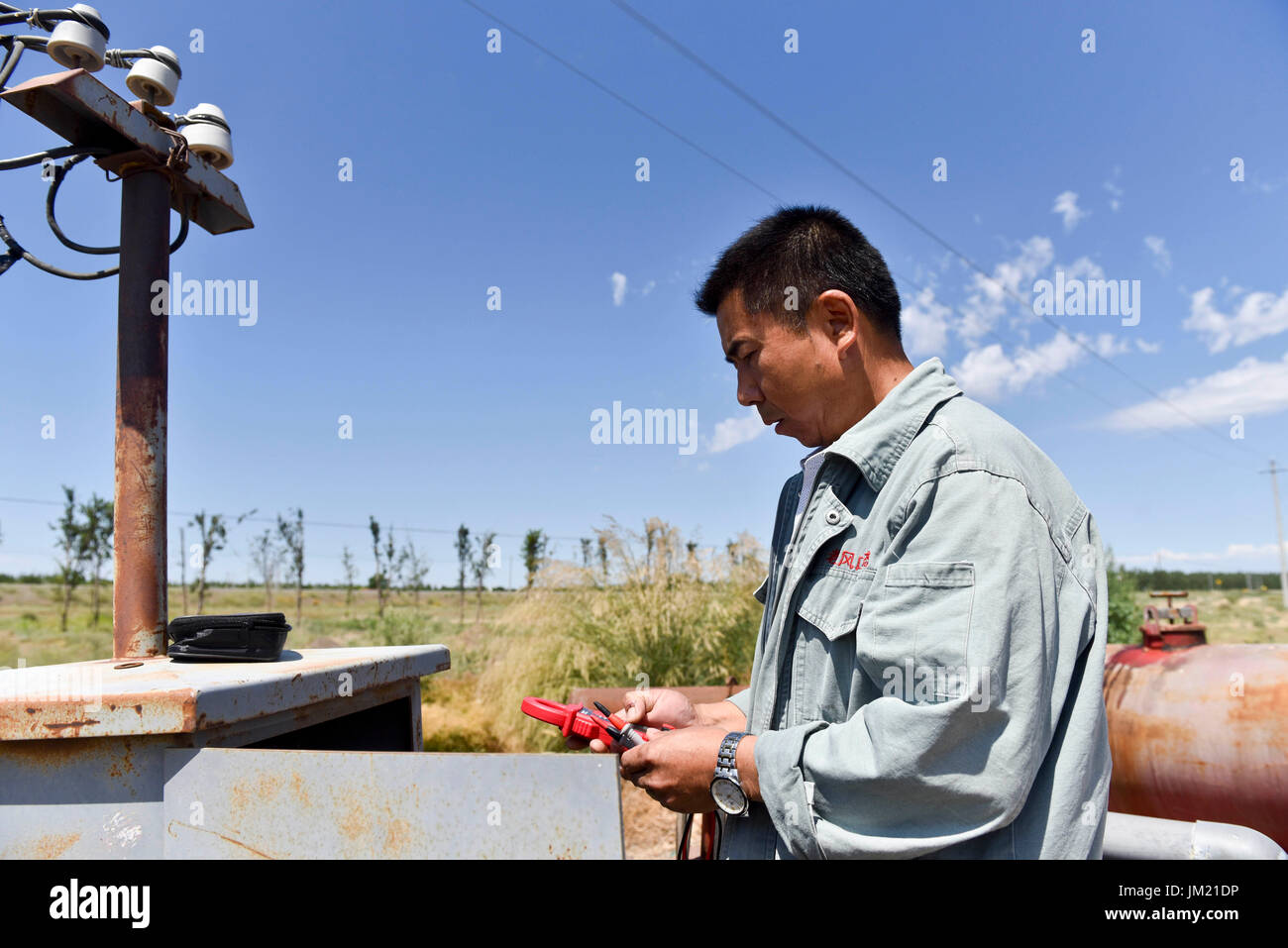 Tacheng. 21st July, 2017. An inspector checks electricity system in the ...
