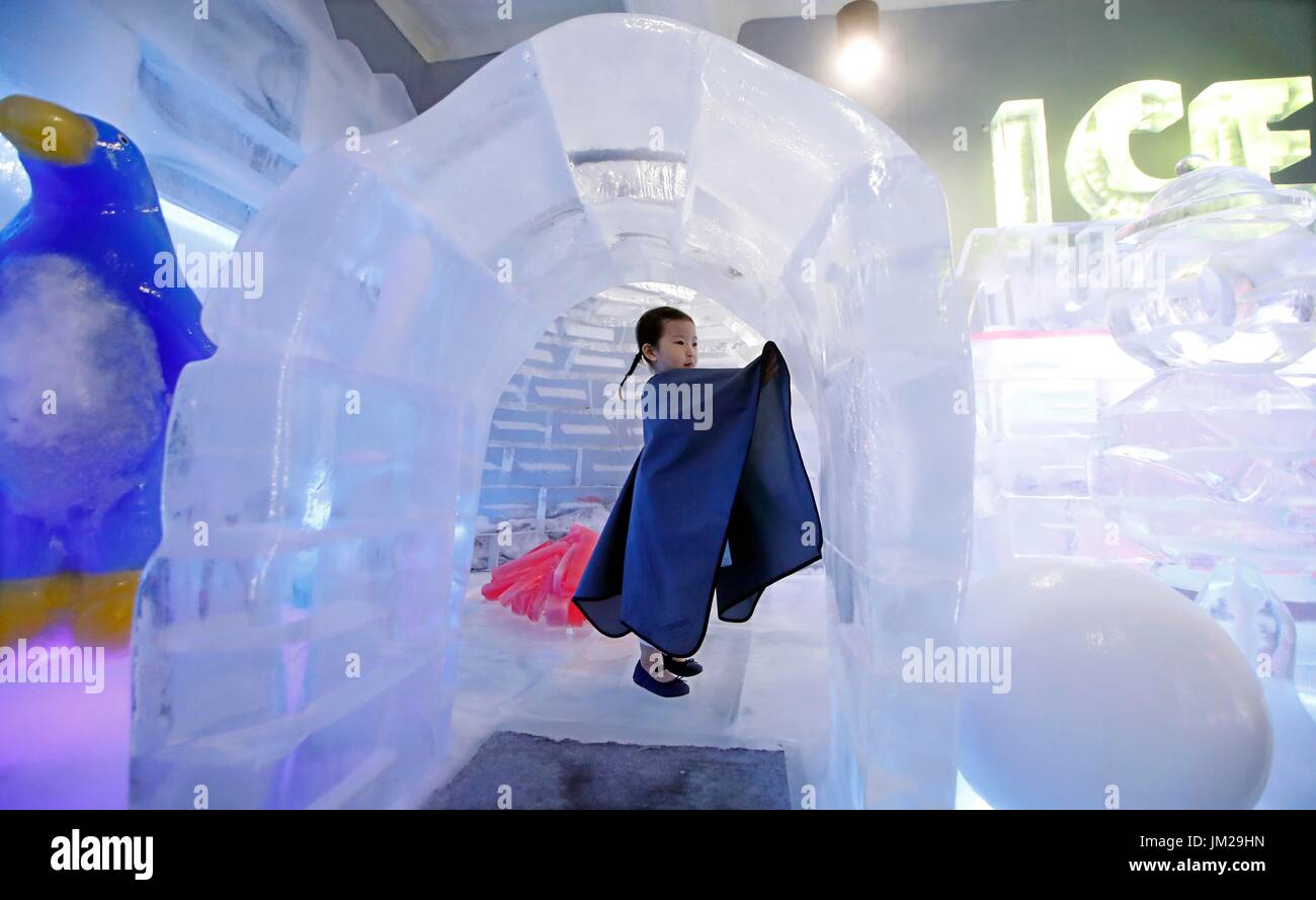 One way to stay cool A child stands inside an ice igloo in an ice cafe ...