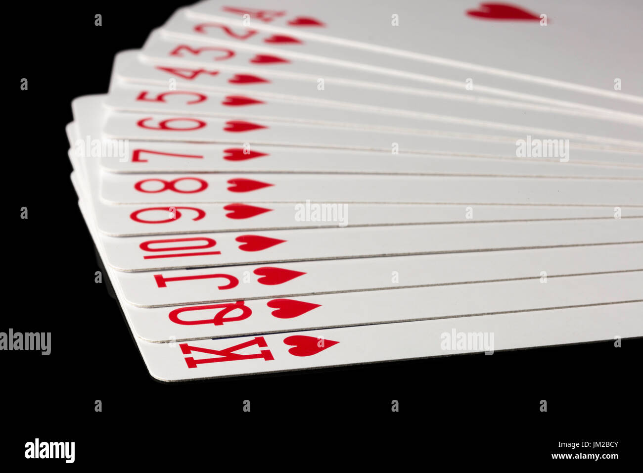 Hearts Playing Cards Spread Out on black background Stock Photo - Alamy