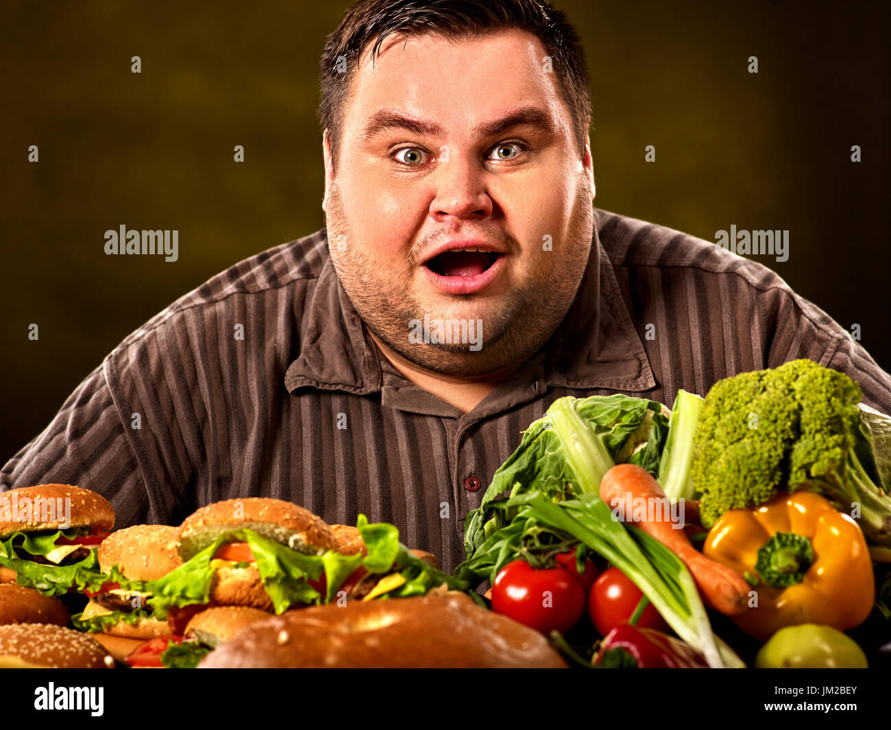 Fat man makes choice between healthy and unhealthy food Stock Photo - Alamy Fat man makes choice between healthy and unhealthy food Stock Photo - Alamy