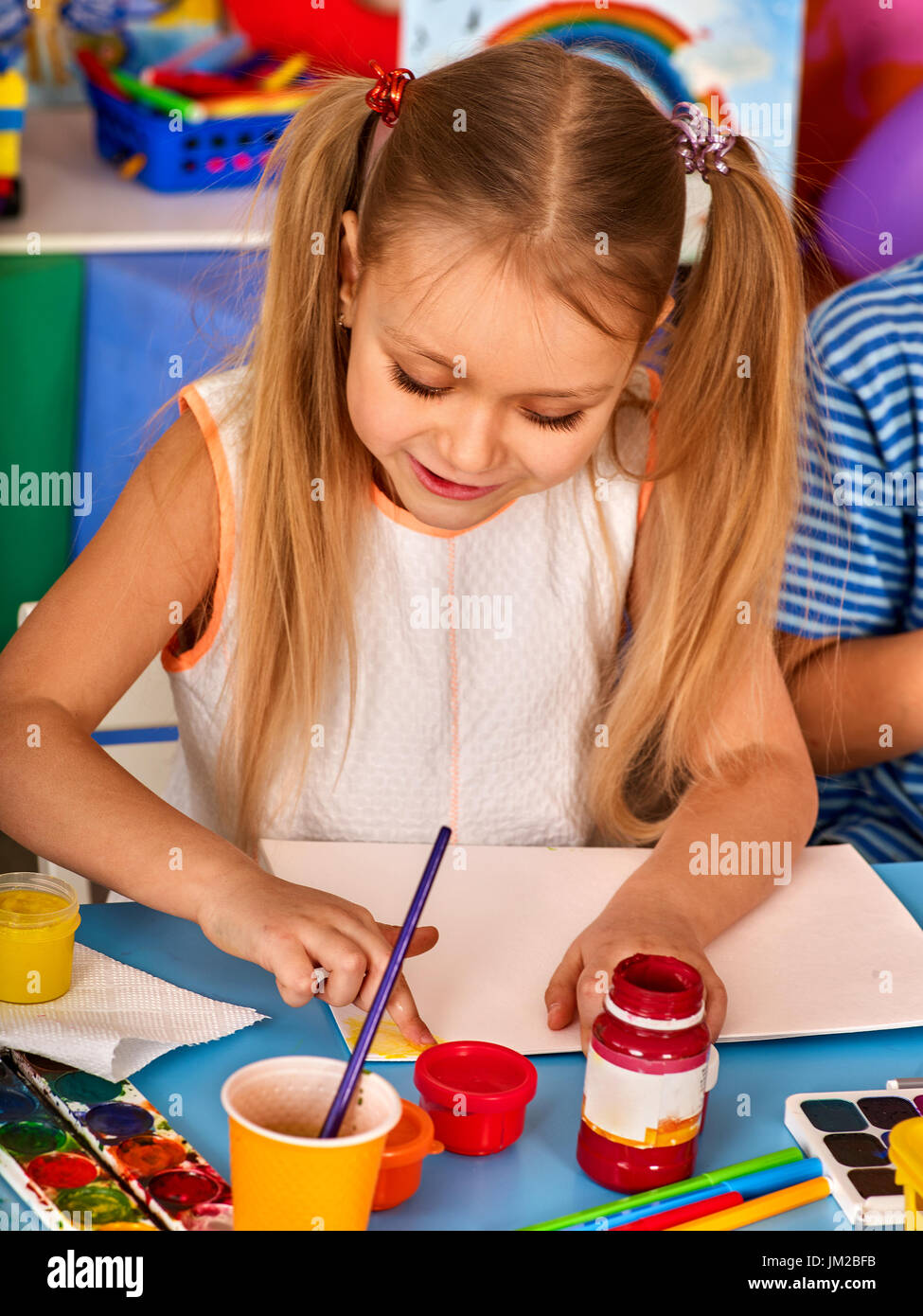 Small students girl painting in art school class Stock Photo - Alamy