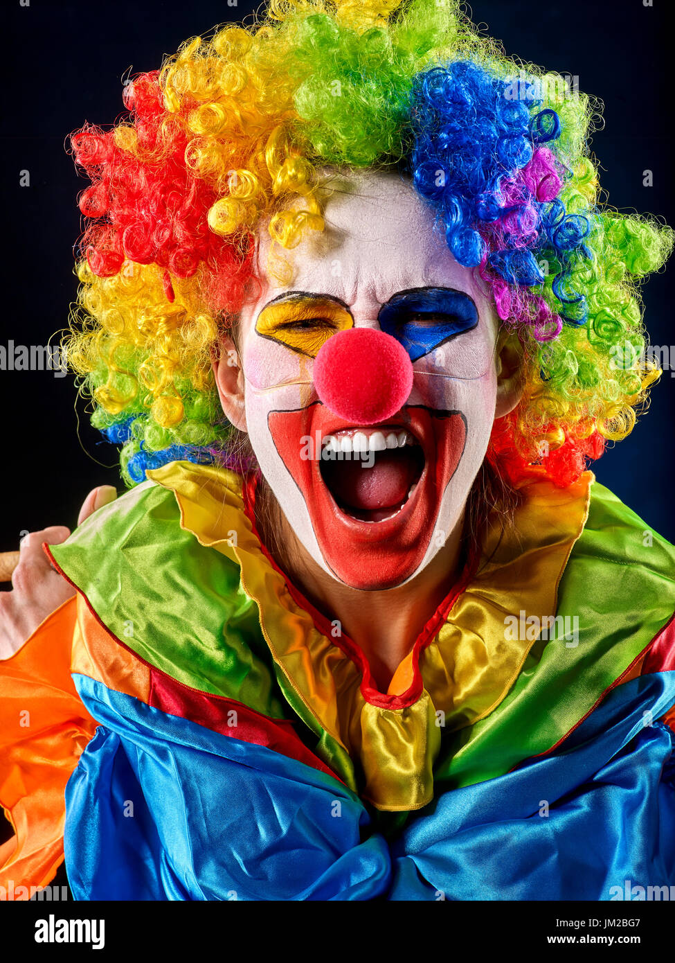 Mad clown on black background. Portrait of crazy woman Stock Photo - Alamy