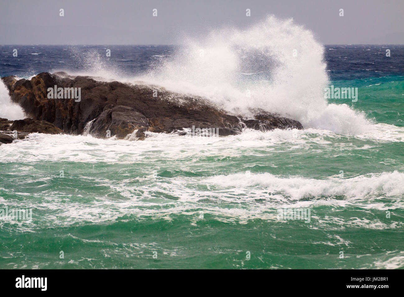 The wave crashed at rock in windy day Stock Photo - Alamy