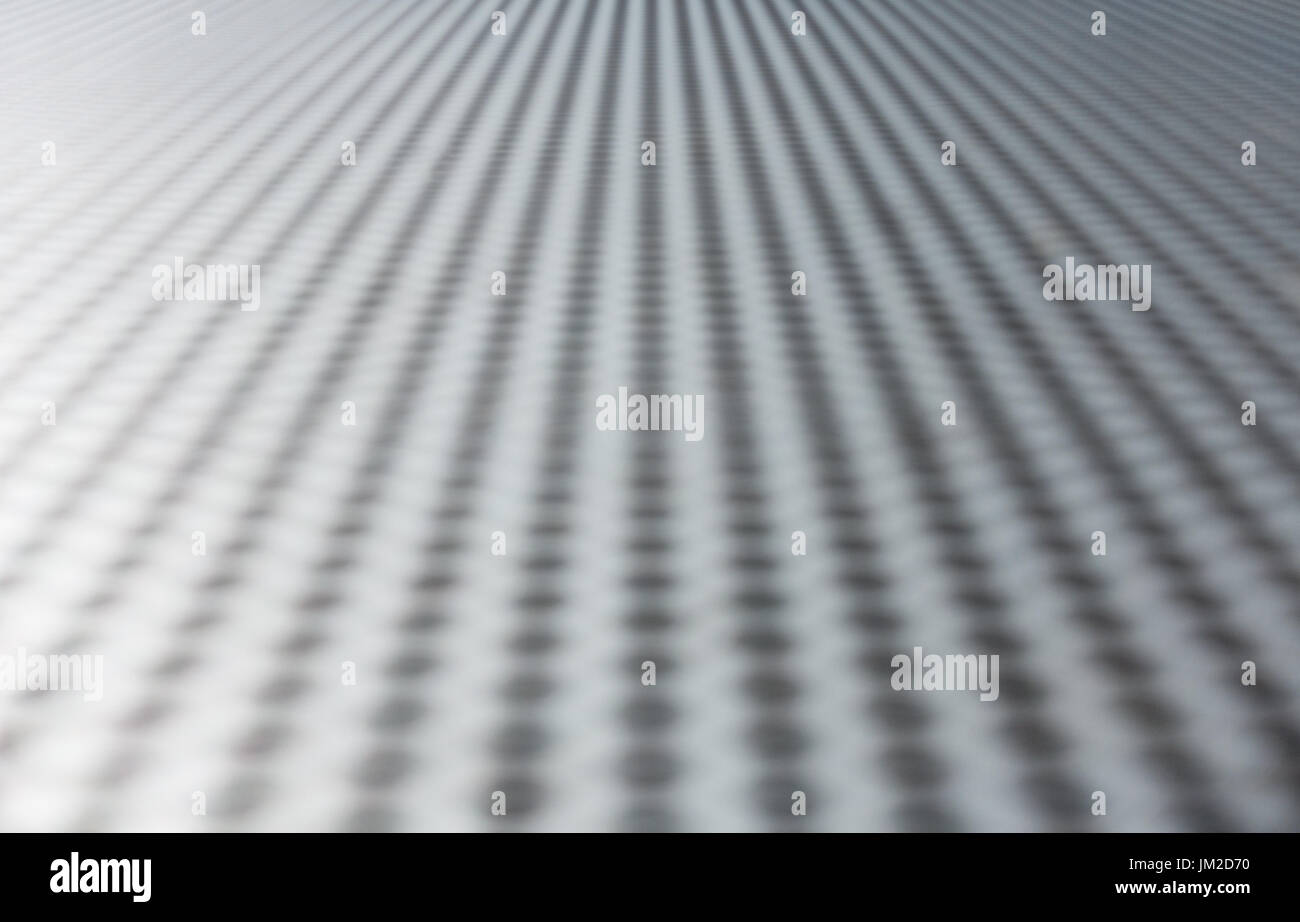 Gray metal background, round perforated metal texture. Reflections and ...