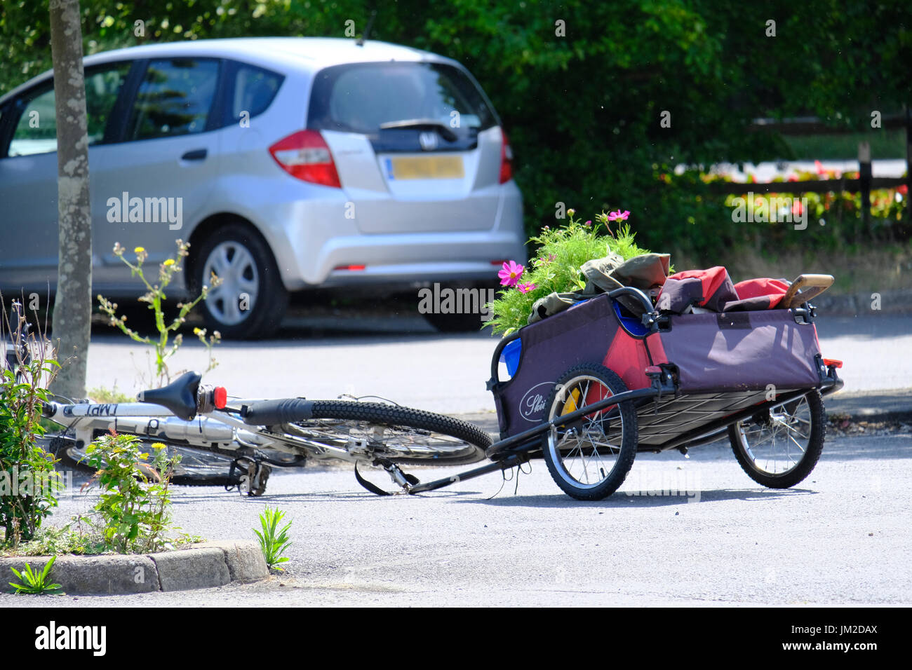 Bicycle with trailer left in car parking space at a farm shop in West ...