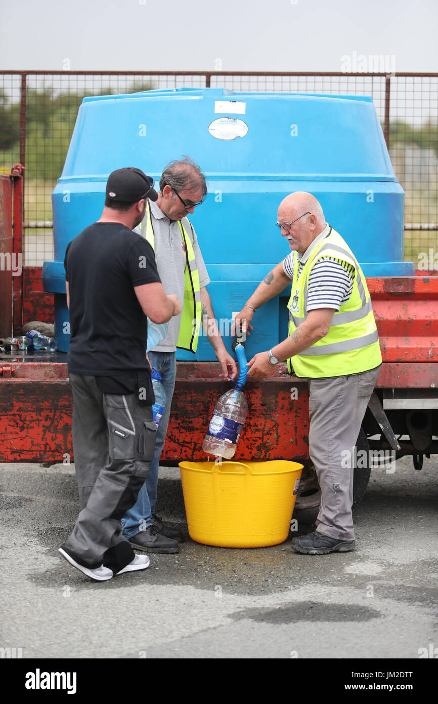 Residents at Termon Abbey in Drogheda queue for water supplied by ...