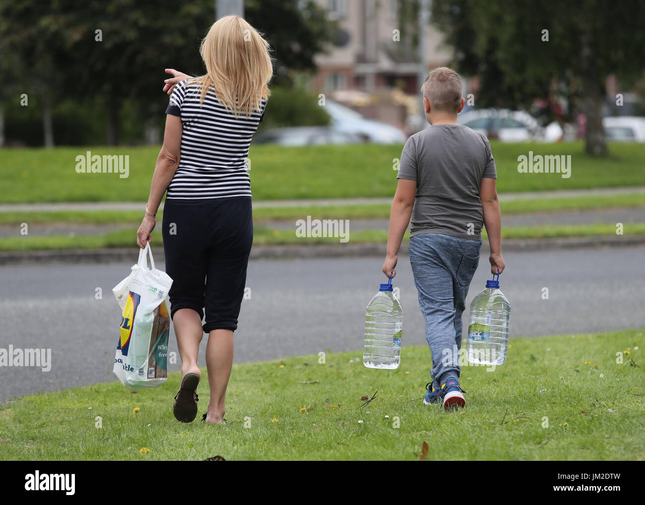 Residents at Termon Abbey in Drogheda carry water supplied by Drogheda ...