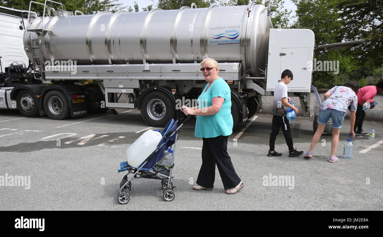 People collect water from a Northern Ireland Water Tanker outside ...