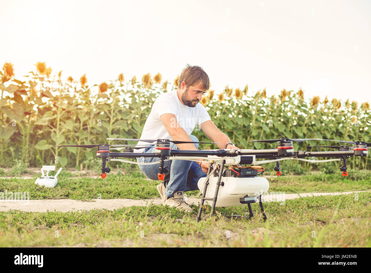 Preparing a drone for take off despite the sunset Stock Photo - Alamy