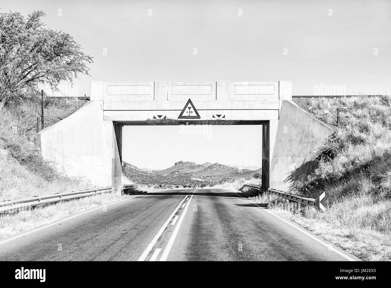 A monochrome view of a railway bridge over the B1-road frames a ...