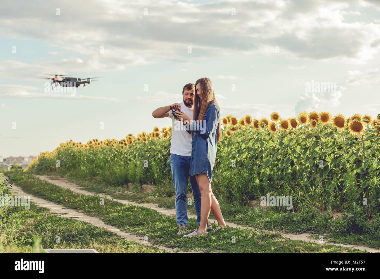 Young man operating of flying drone octocopter at the green field Stock ...