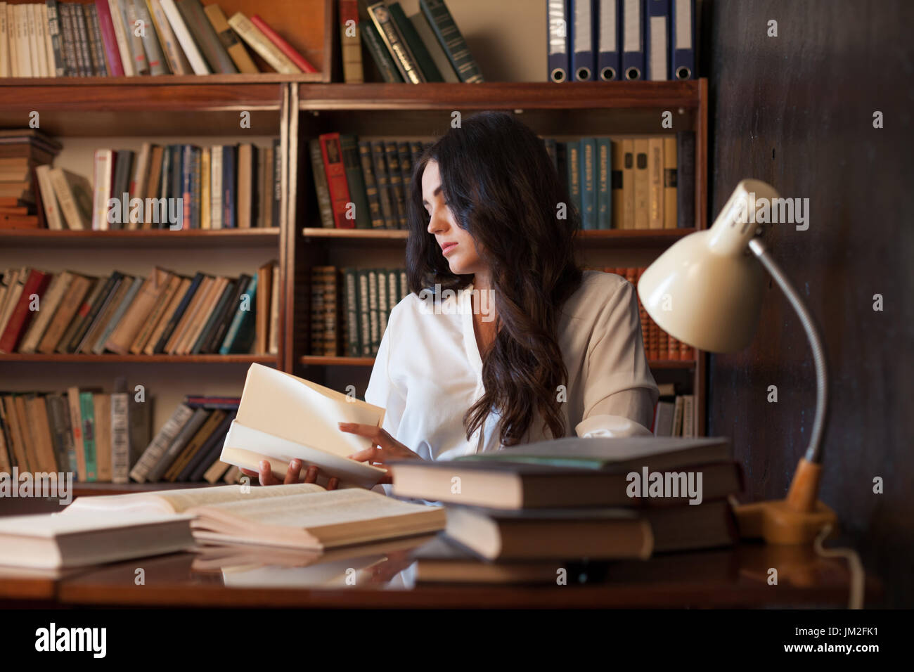 girl is preparing for the exam reading book at the library Stock Photo ...