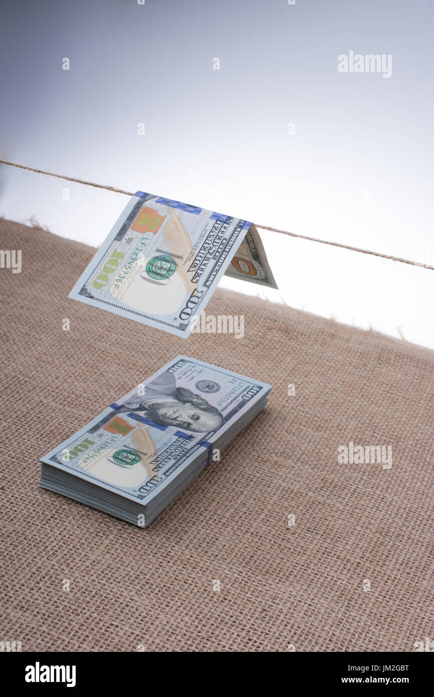 Banknote of US dollar hanging on a linen string Stock Photo - Alamy